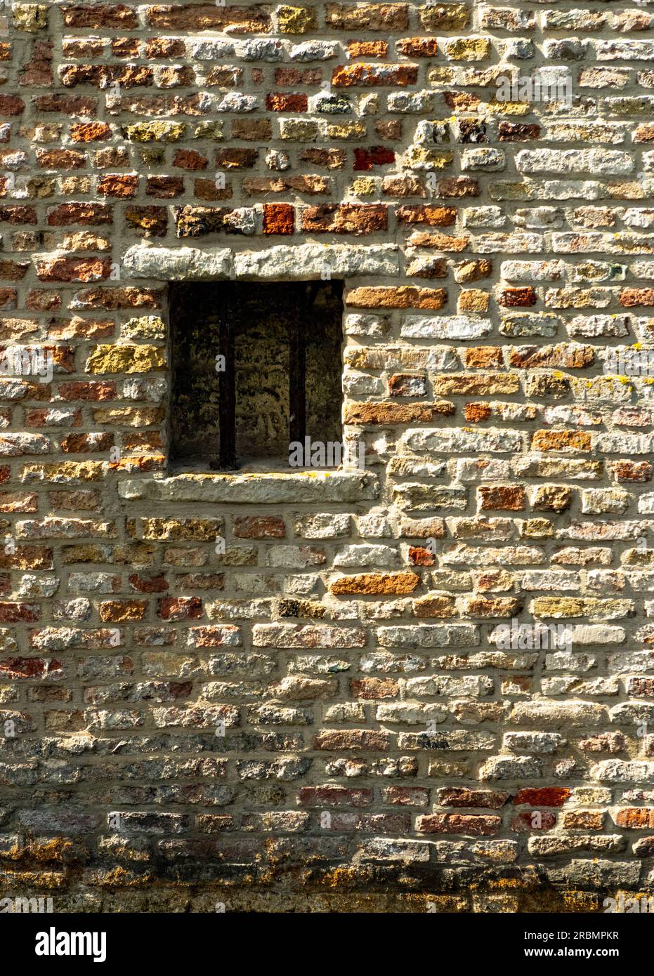 Brick wall with a small opening Stock Photo - Alamy