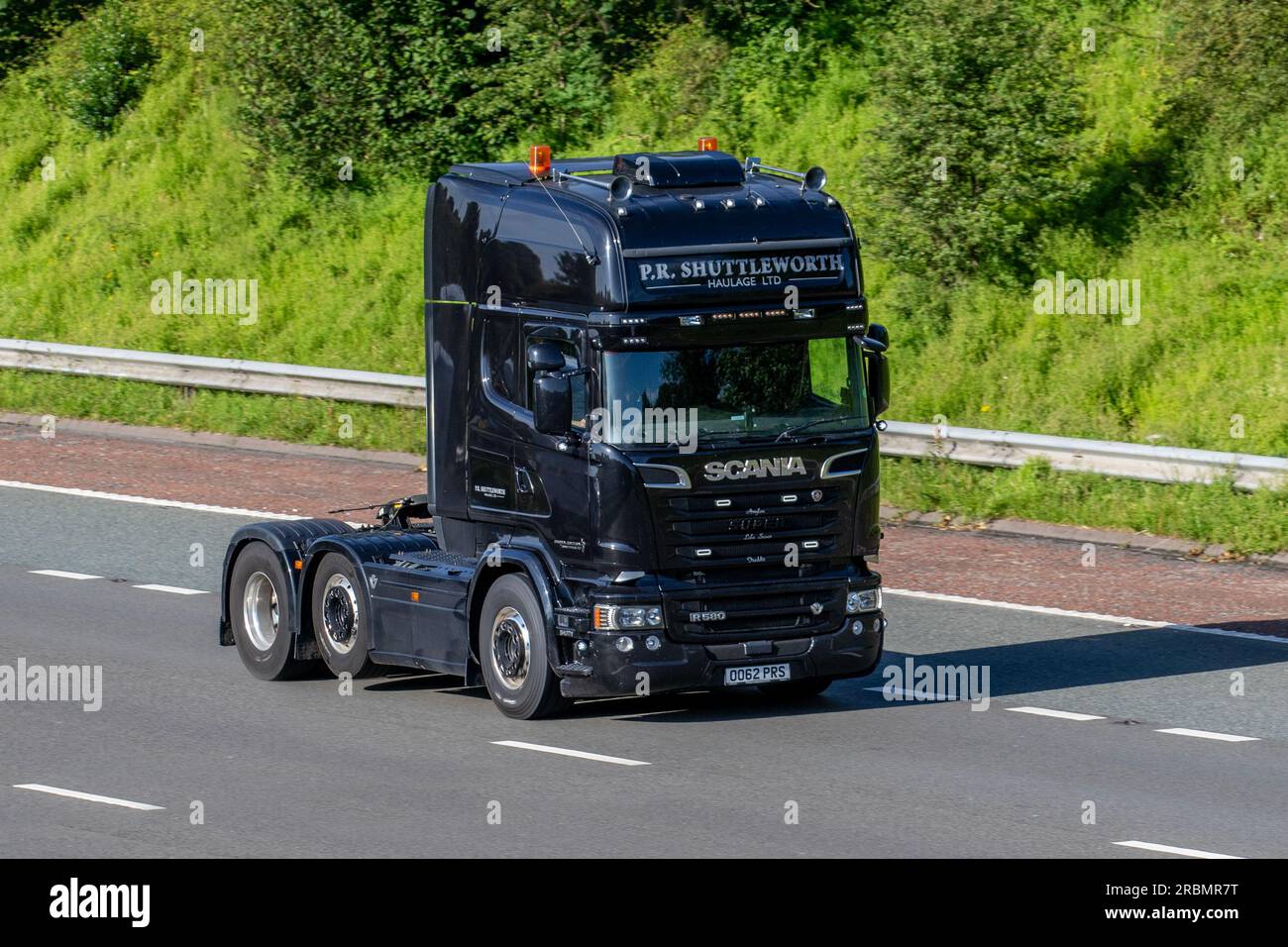 P.R. SHUTTLEWORTH Haulage Ltd Black Scania R580 tractor unit travelling ...