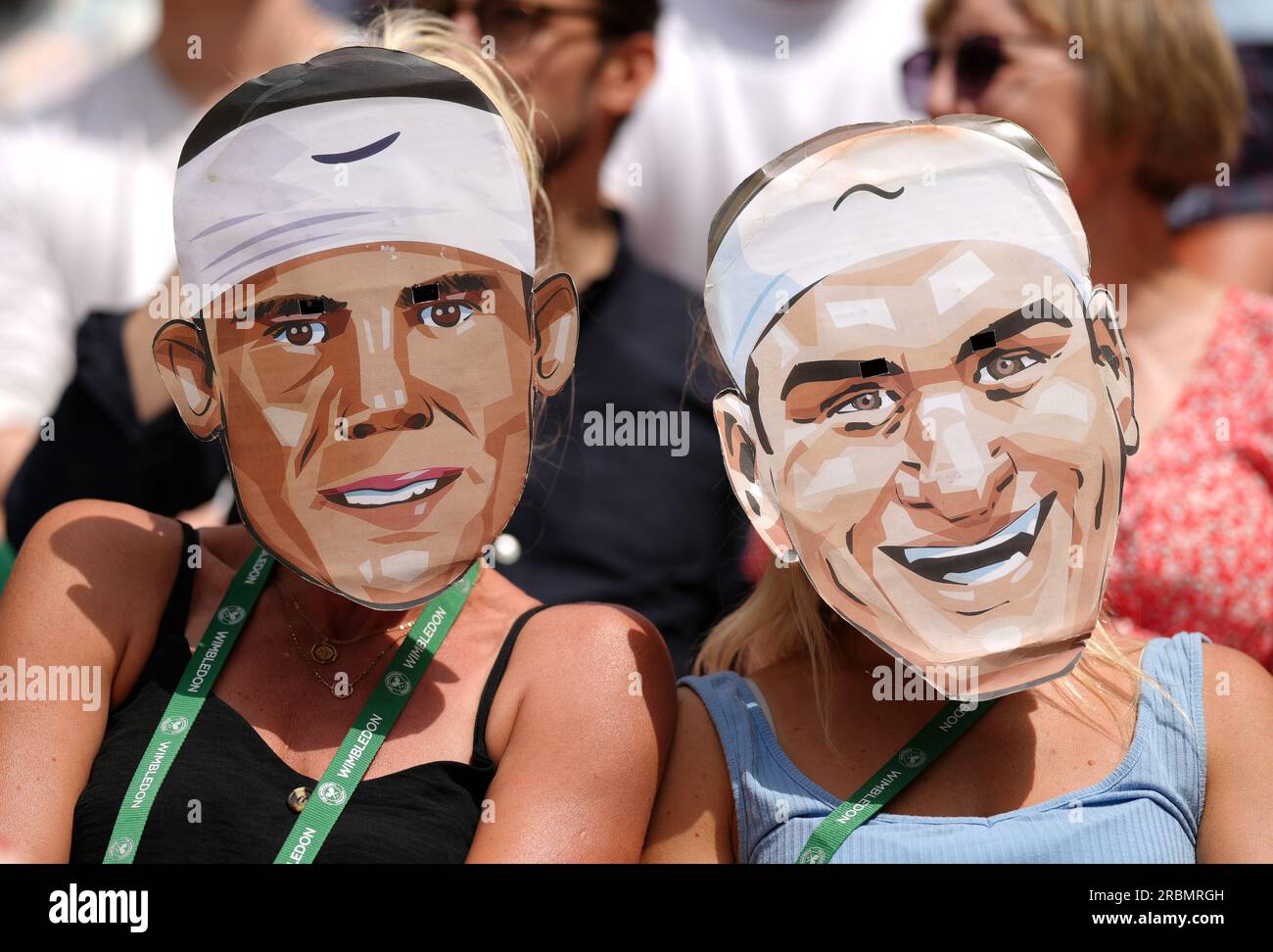 Spectators on centre court sporting face masks of Roger Federer and ...