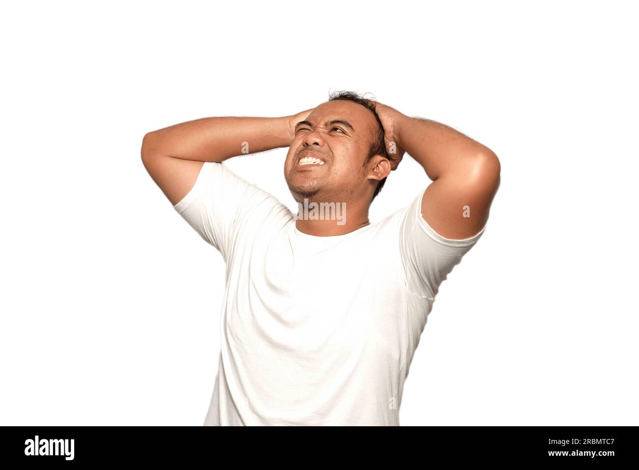 A photo of a Asian man stressed two hands holding stress head wearing a ...
