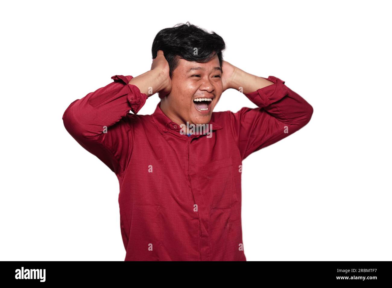 A photo of a Asian man stressed two hands holding stress head wearing a ...