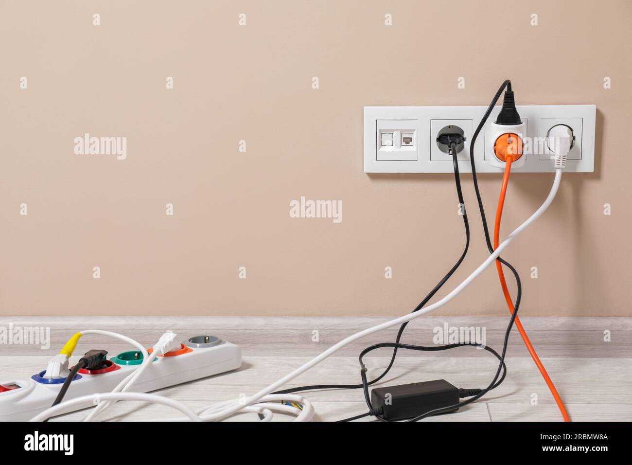 Extension cord with power plugs in sockets indoors, space for text ...
