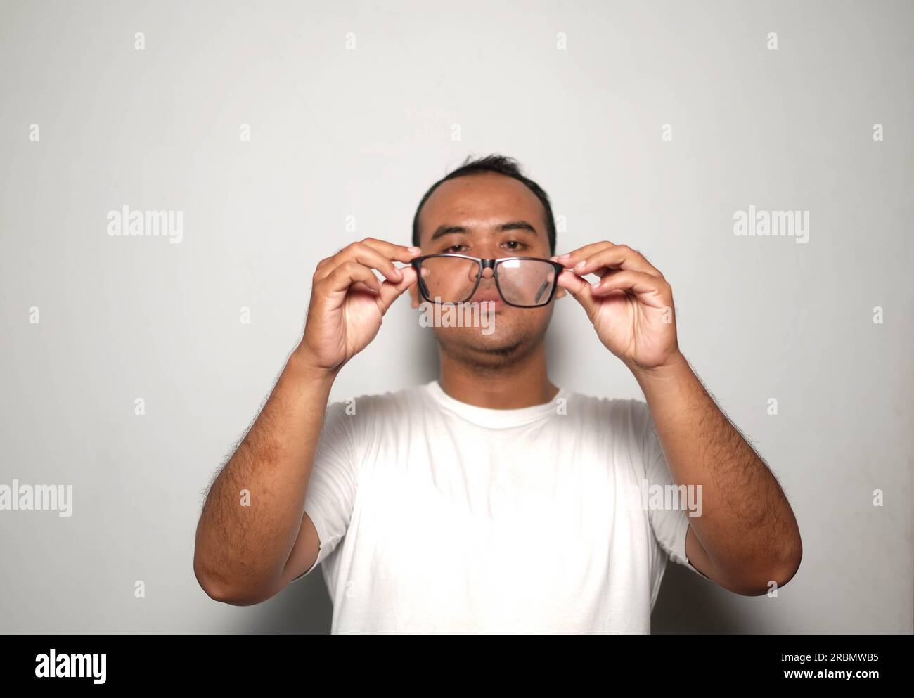 asian man putting up, using glasses Stock Photo - Alamy