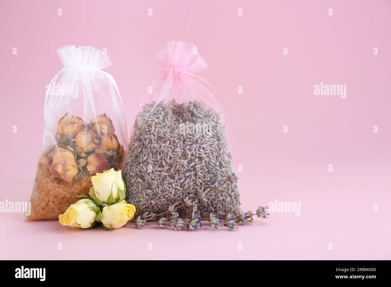 Scented sachets with dried roses, sea salt and lavender flowers on pink ...