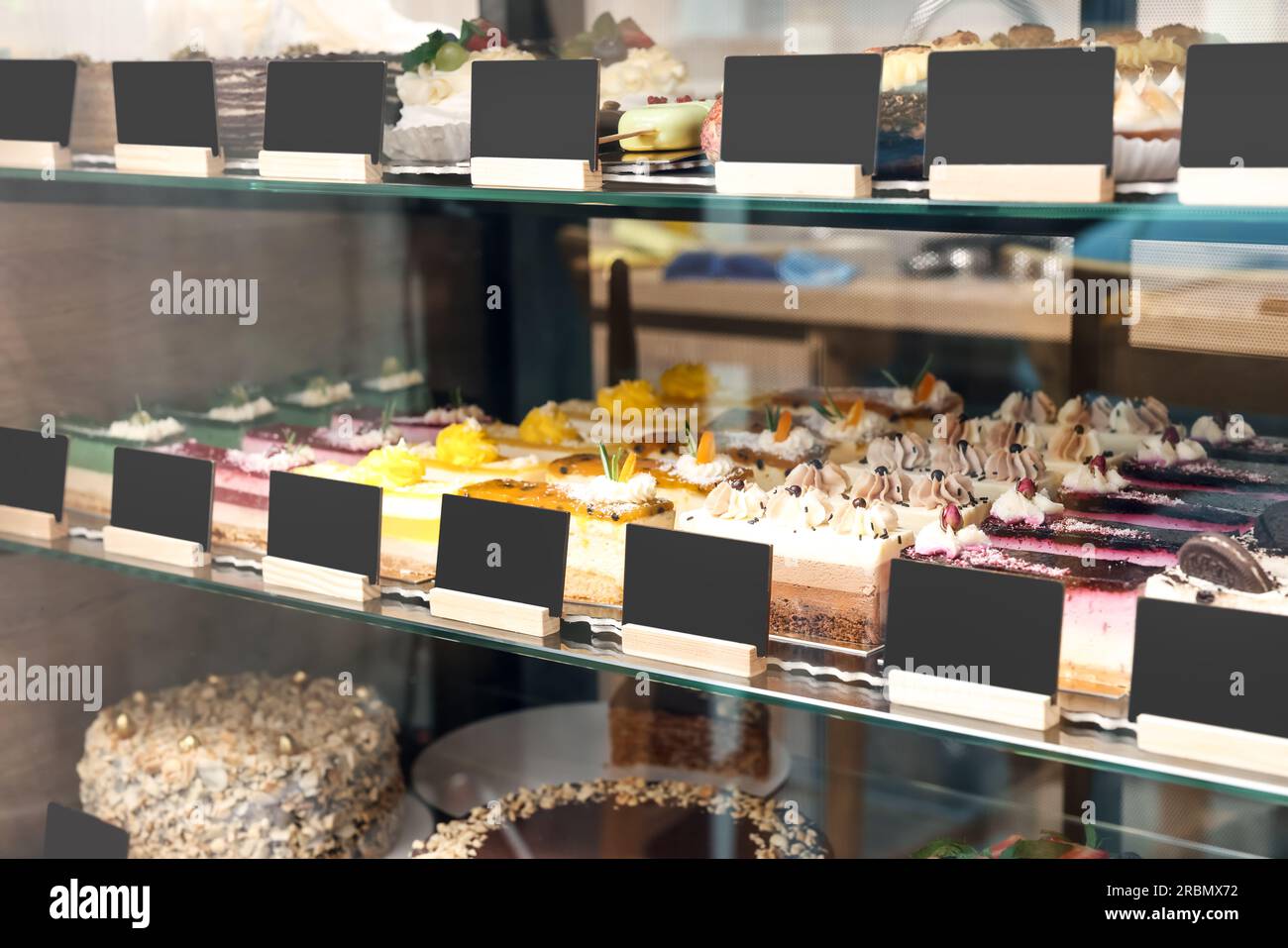 Showcase with different tasty desserts in bakery shop, closeup Stock ...