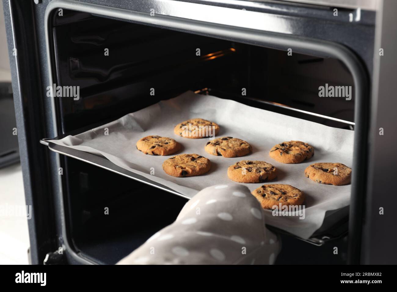 Taking cookies from oven hi-res stock photography and images - Alamy