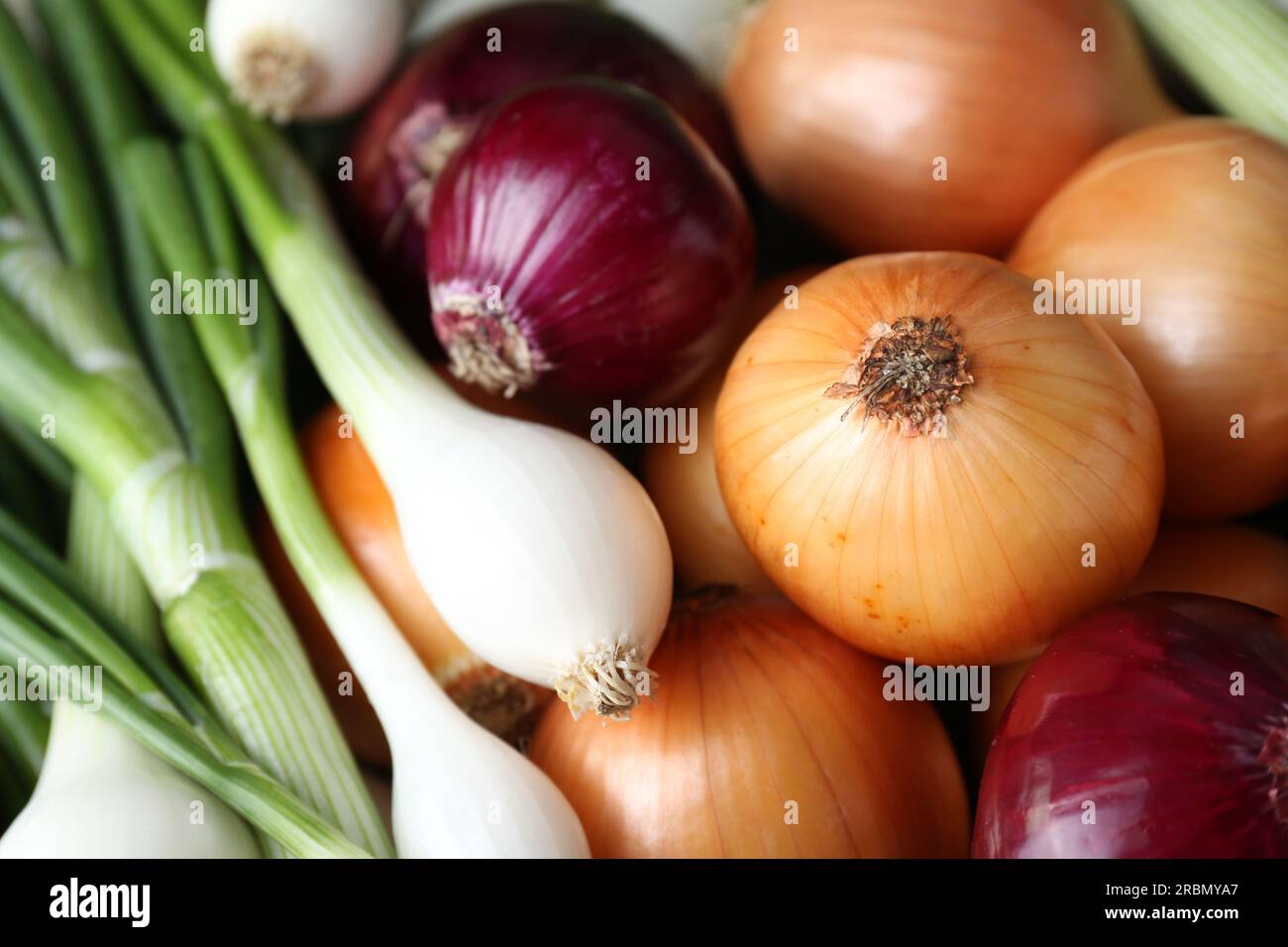Different kinds of onions as background, closeup Stock Photo - Alamy