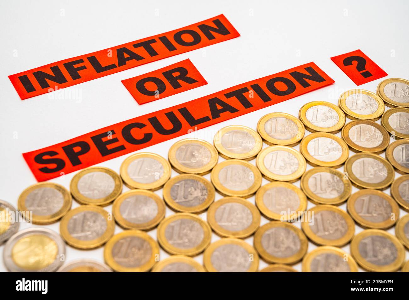 Coins placed next to each other on white surface and text "inflation or ...