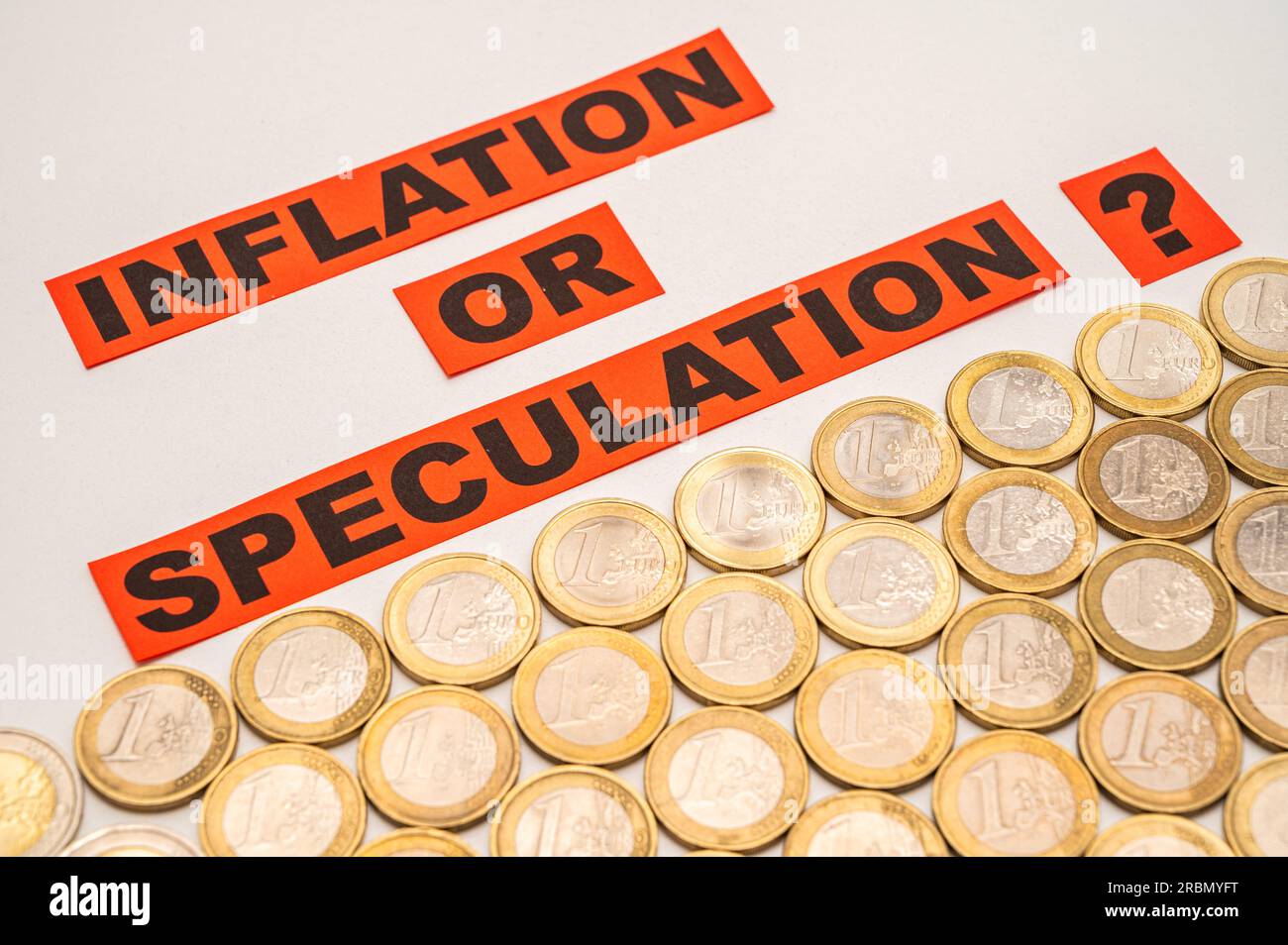 Coins placed next to each other on white surface and text "inflation or ...