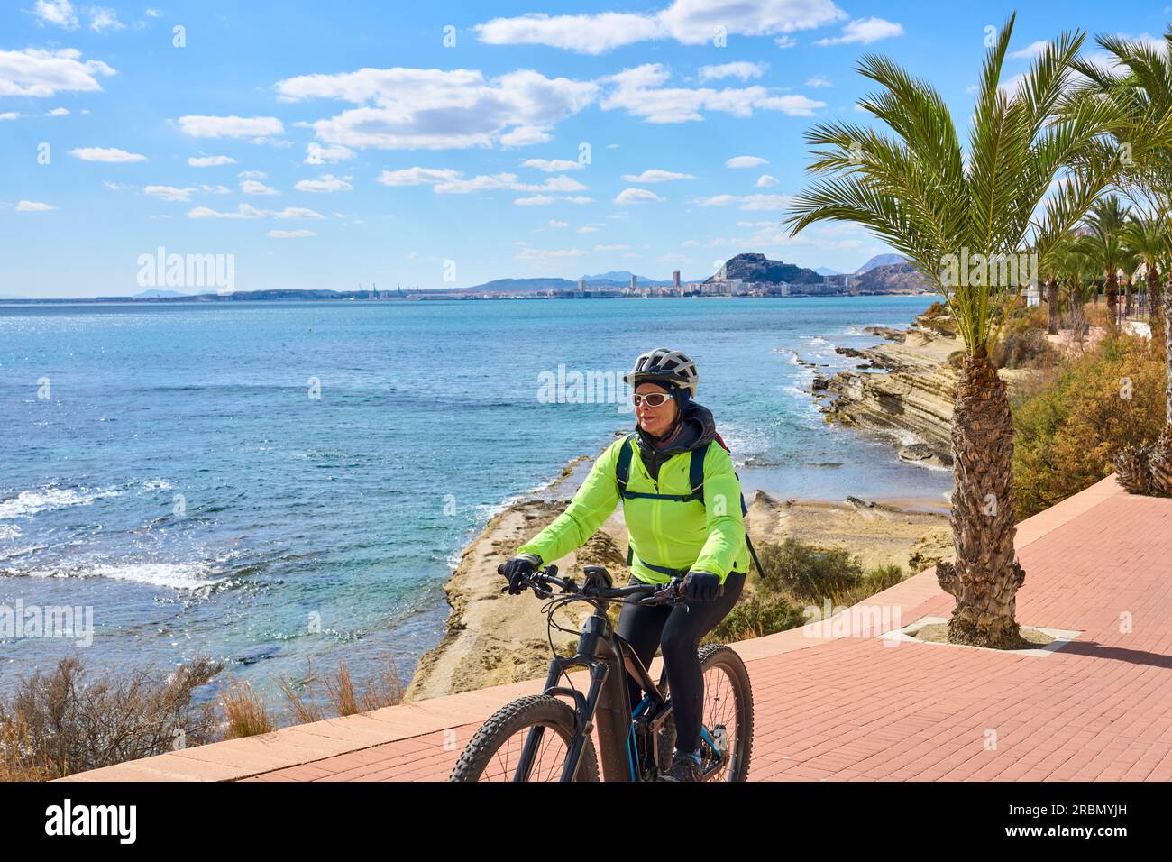 nice senior woman cycling on a cool spring day with her electric ...
