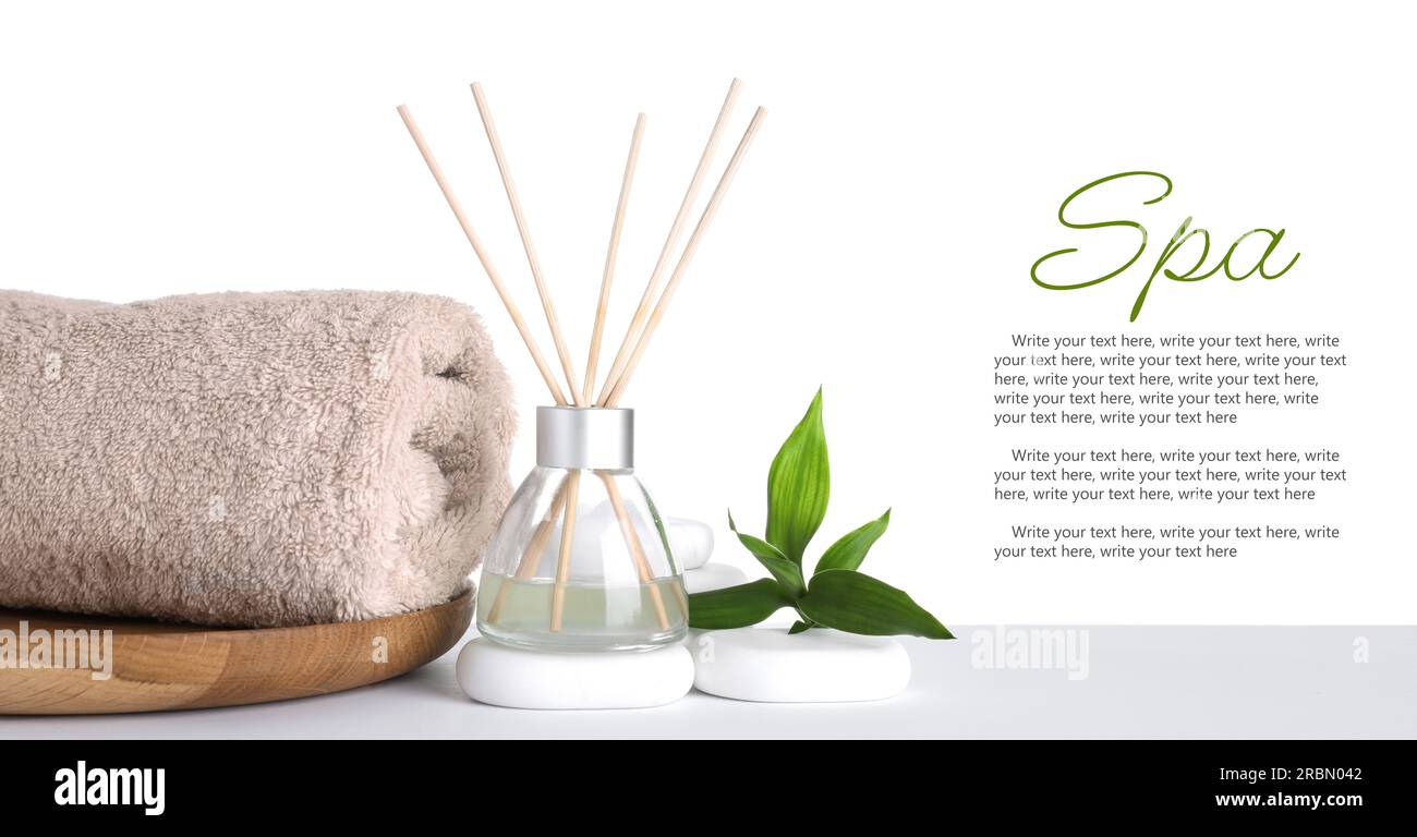 Composition with spa stones and oil reed diffuser on table against ...