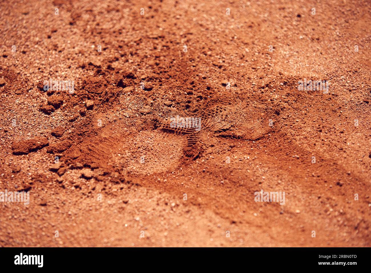 Footprint of leg in sports shoes on sand on open air sport court ...