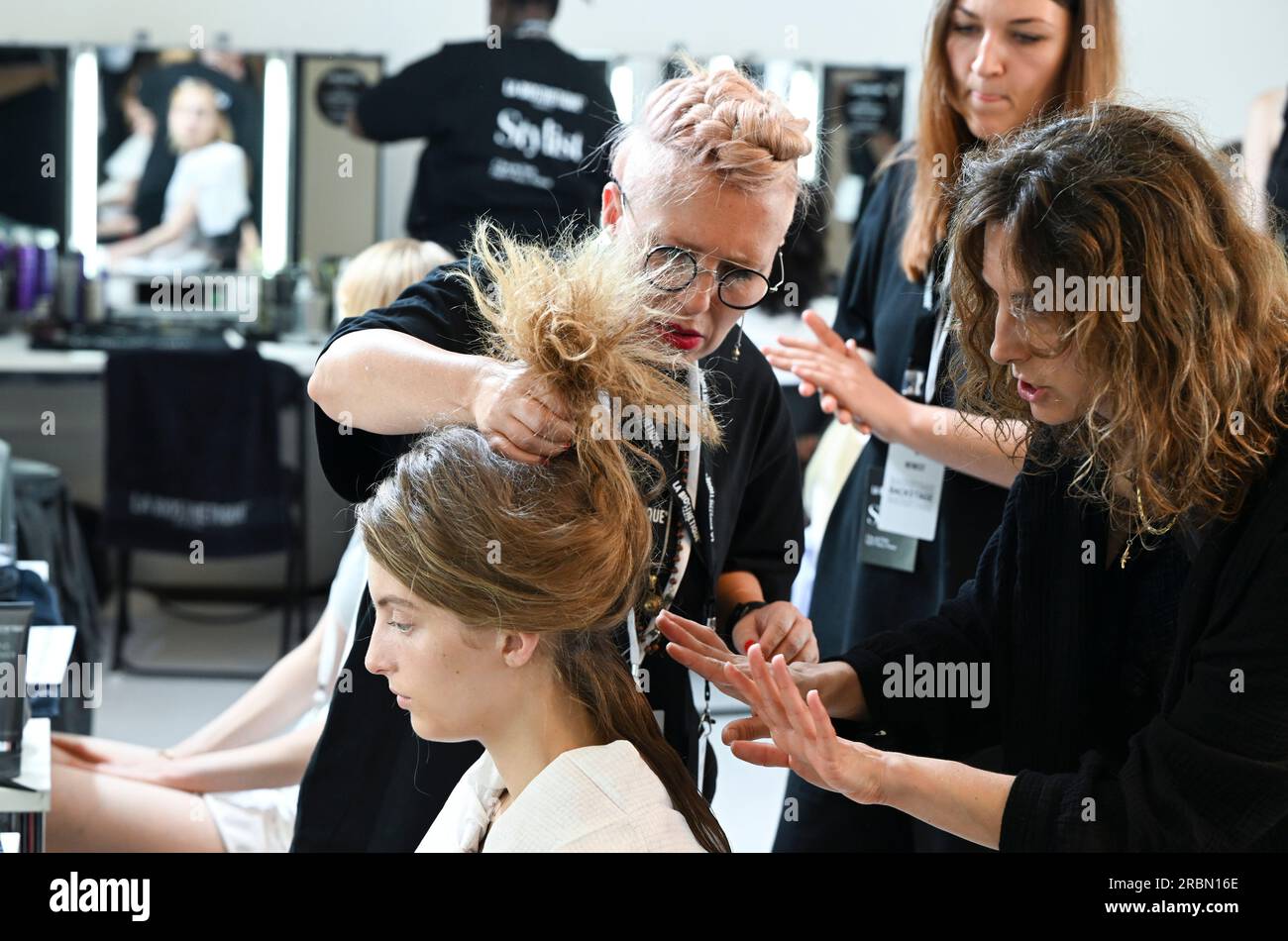 Berlin, Germany. 10th July, 2023. Models are styled backstage before ...
