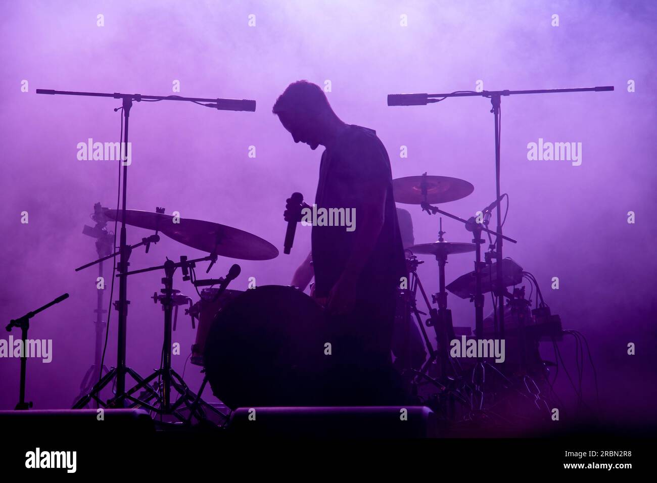 A silhouette of singer hip hop rap musician during live concert in dark ...