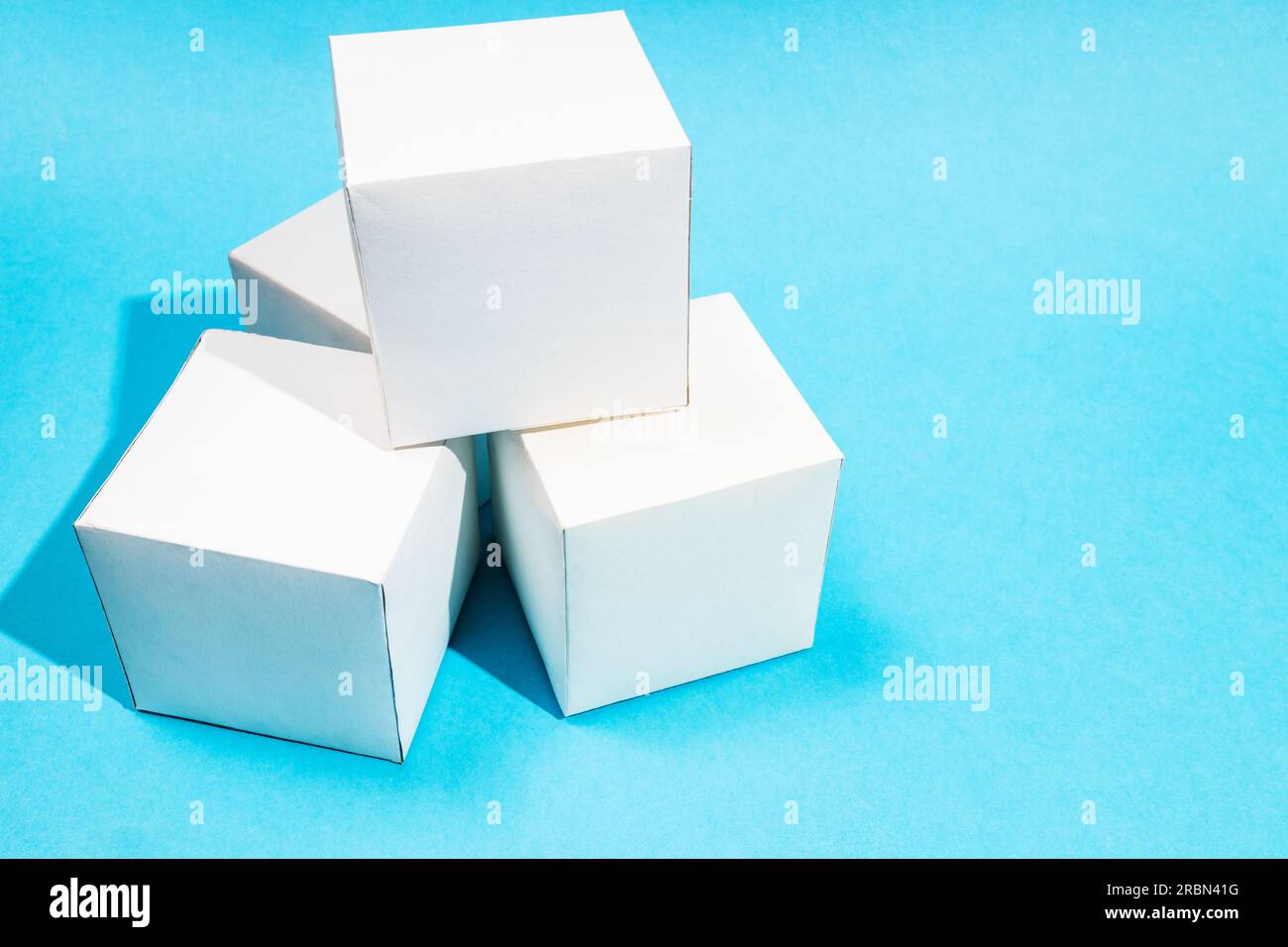 above view of several hand-crafted paper cubes on turquoise blue ...