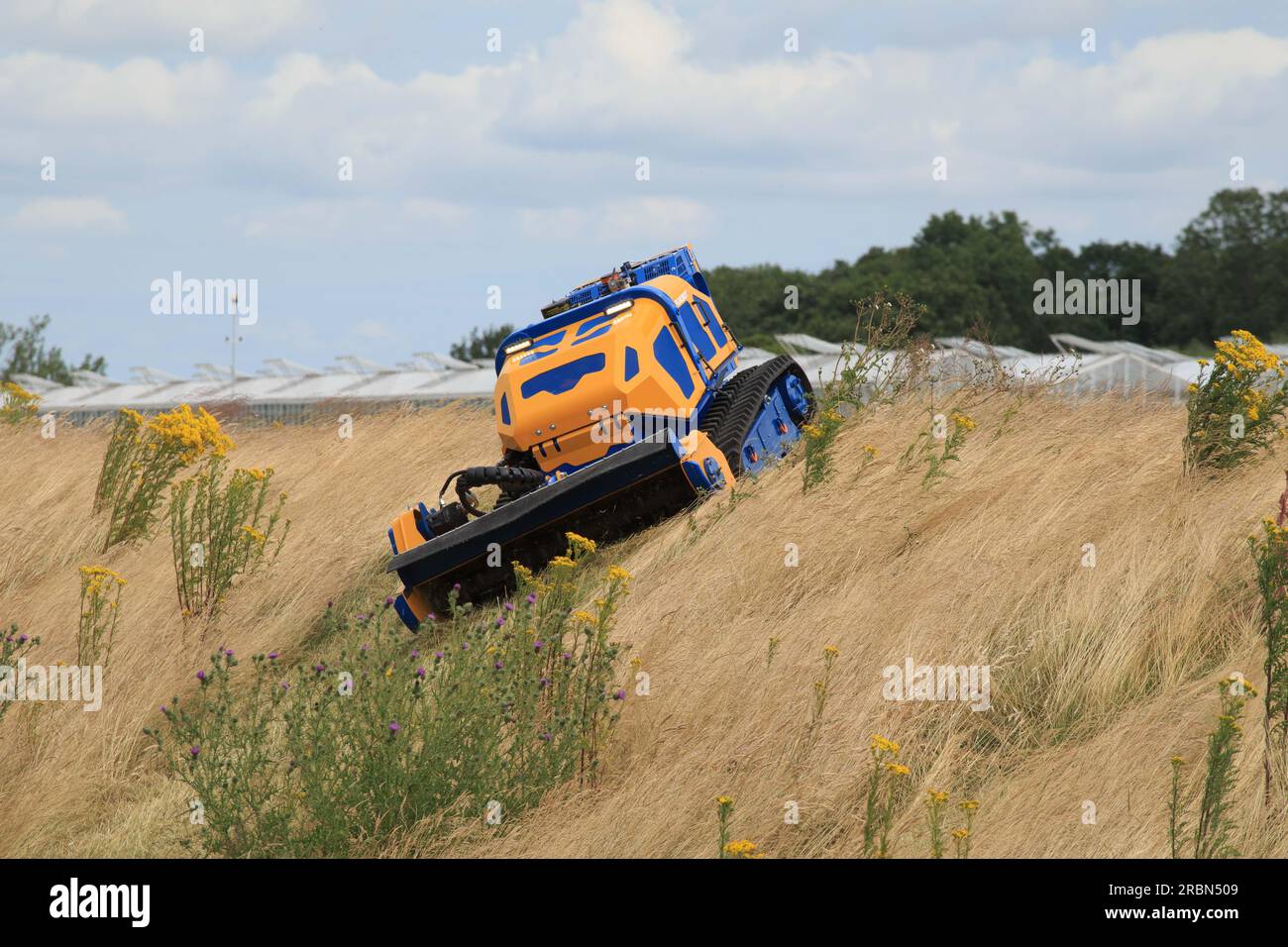 Robotic mowers working on a steep bank Stock Photo - Alamy