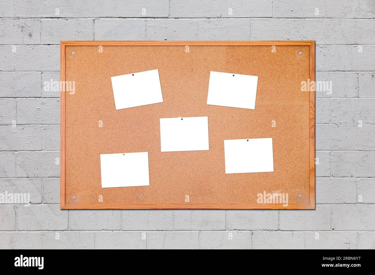 Cork board with five card pined on it with copy space on a painted ...