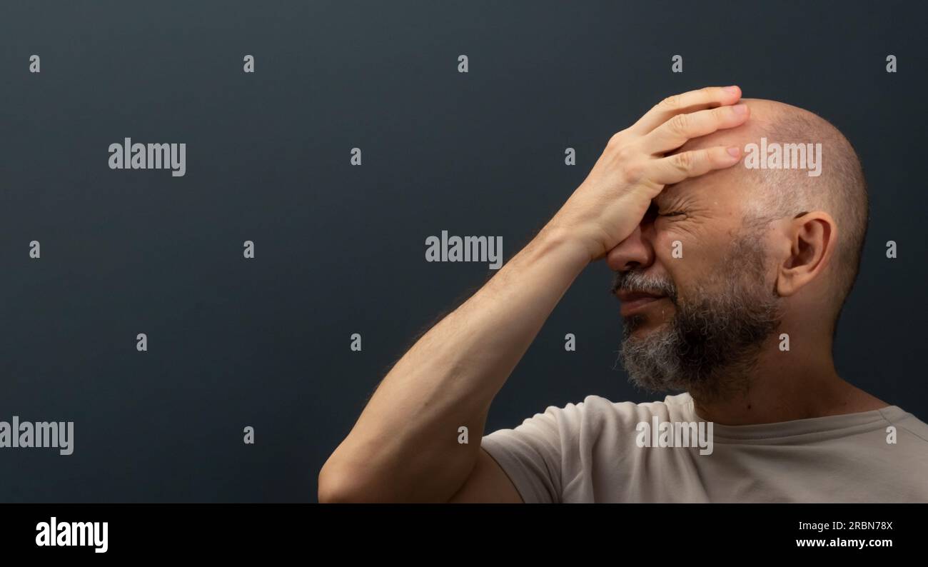 Sad man suffering from headache or migraine. Stressed guy with painful ...