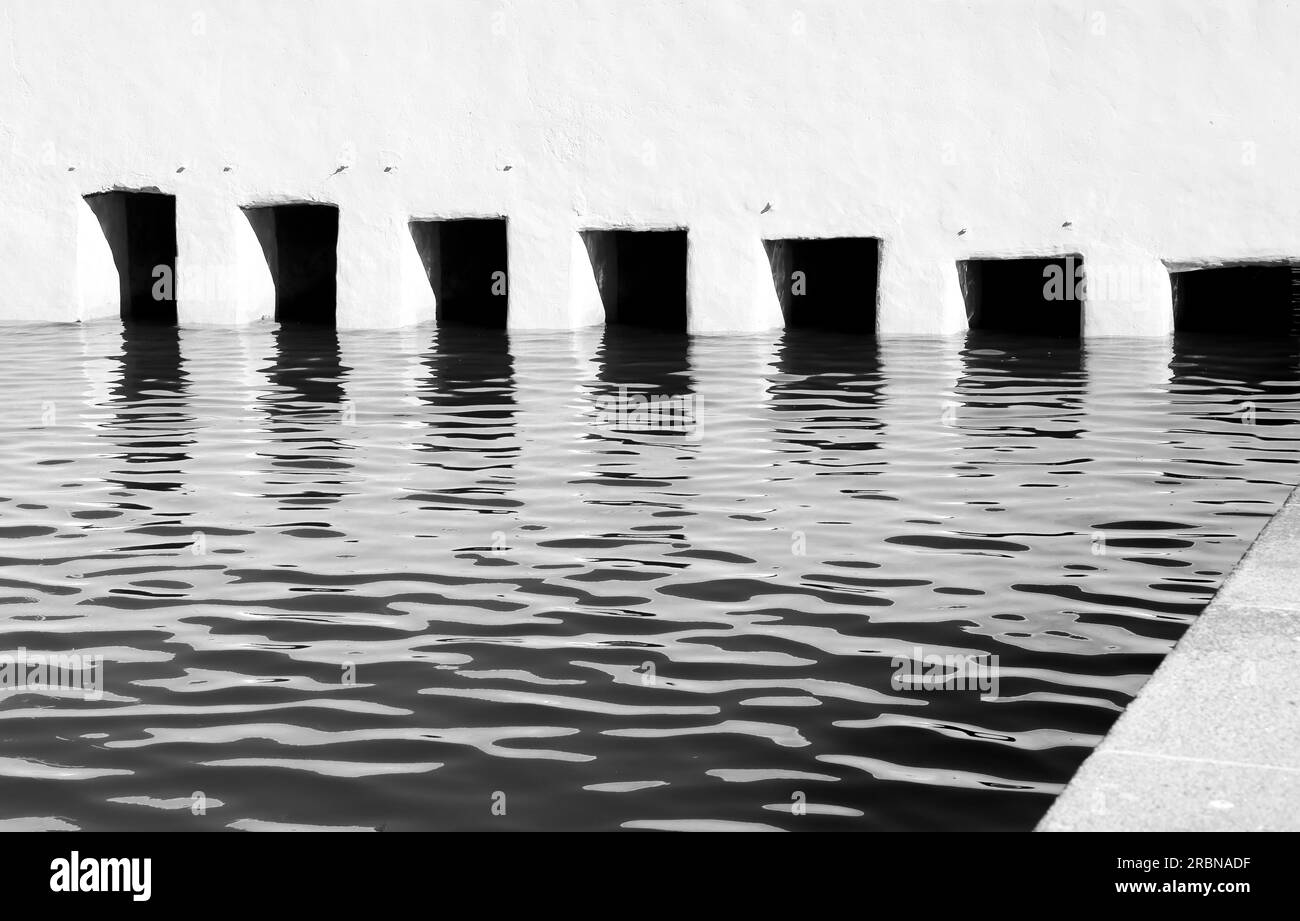 Square openings for the passage of water in a channel . Monochrome ...