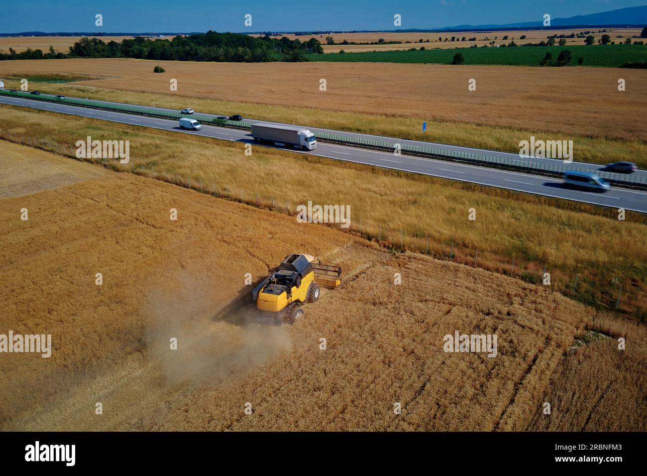 Harvesting machine working at agricultural field. Combine harvester ...