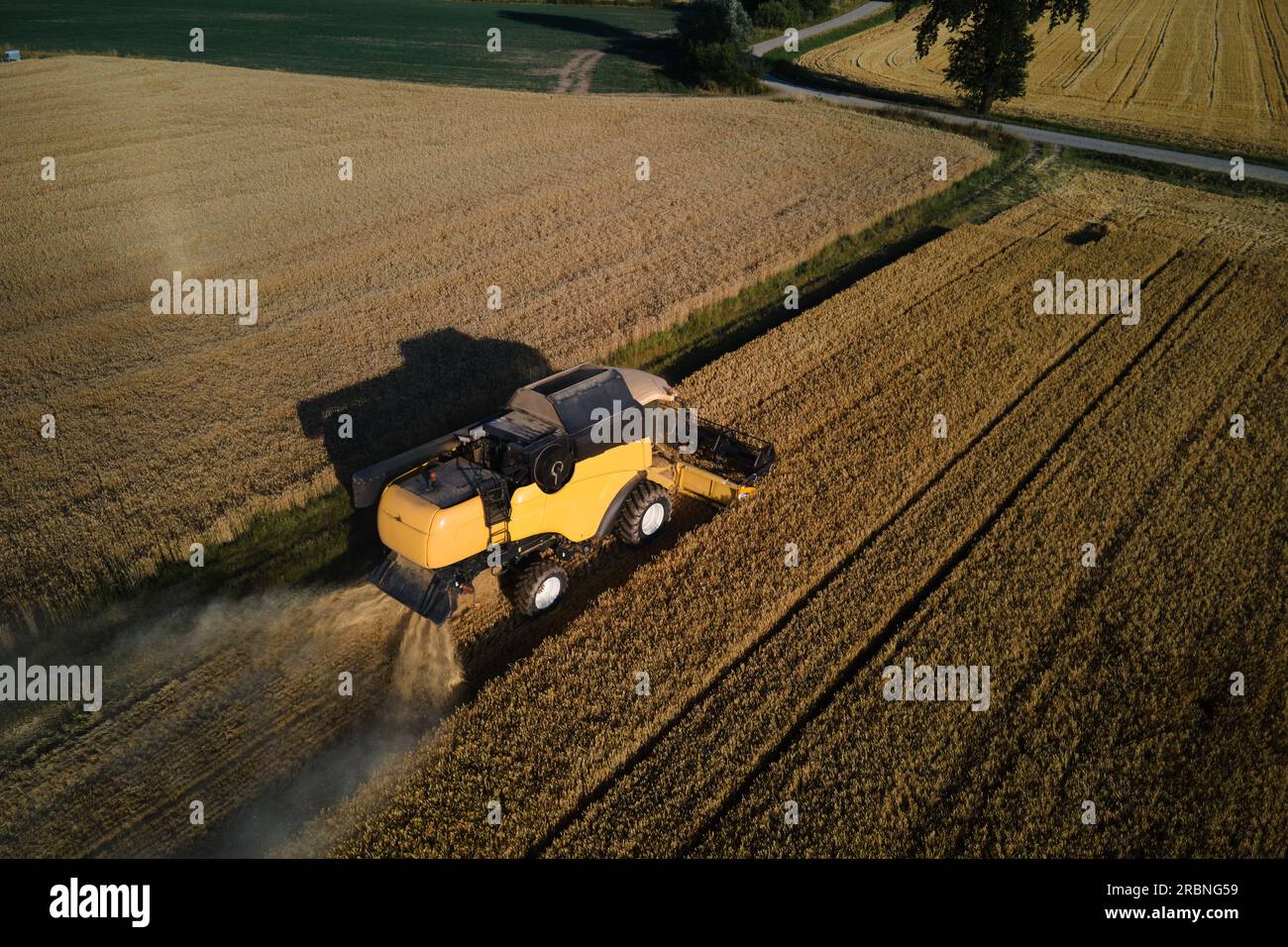 Harvesting machine working at agricultural field. Combine harvester ...