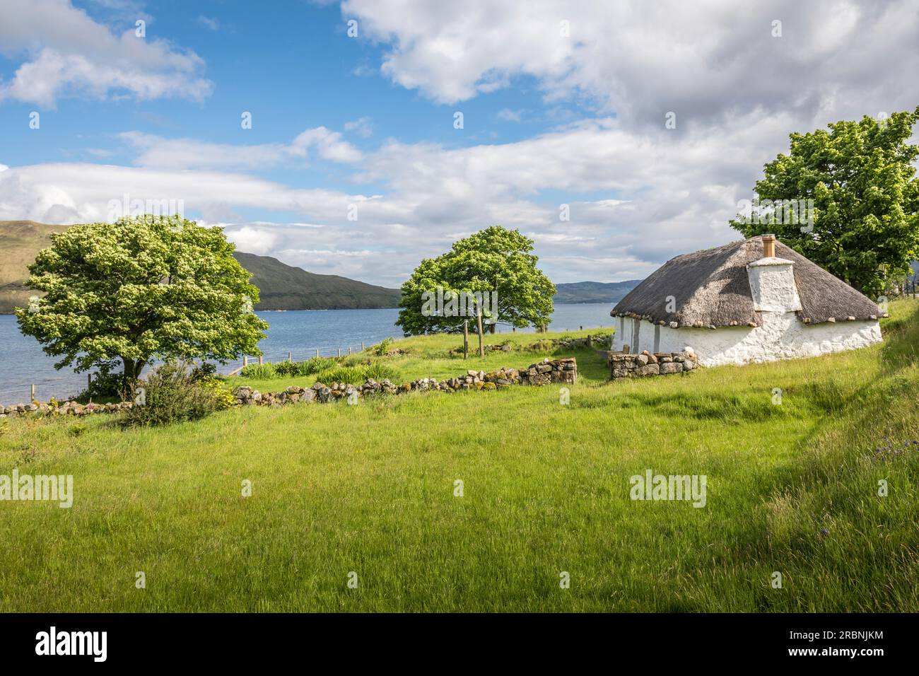 Thatched roof cottage on Loch Airnord near Luib, Isle of Skye ...