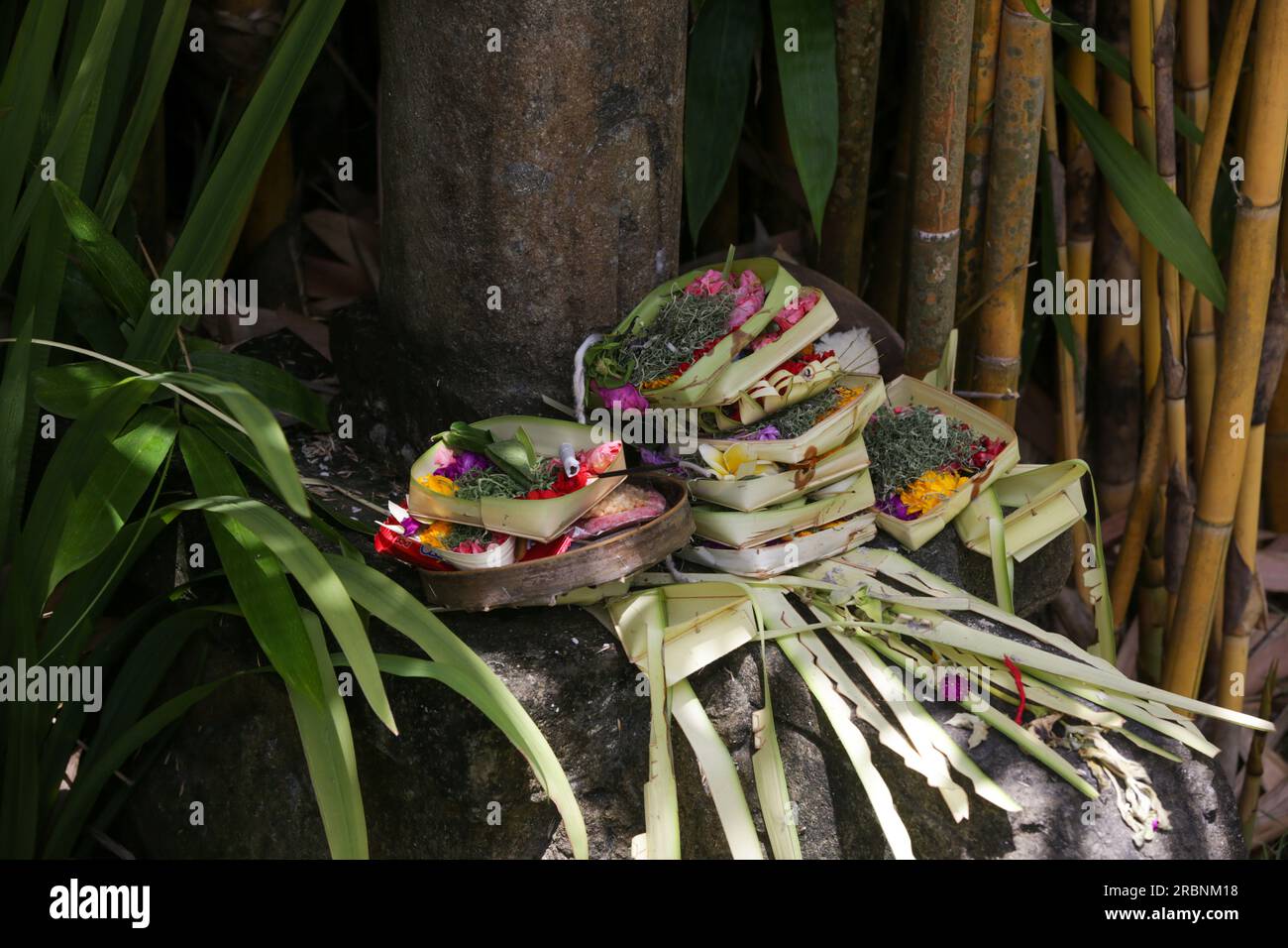 Canang sari, woven bamboo container with rice, flowers, incense, sweets ...