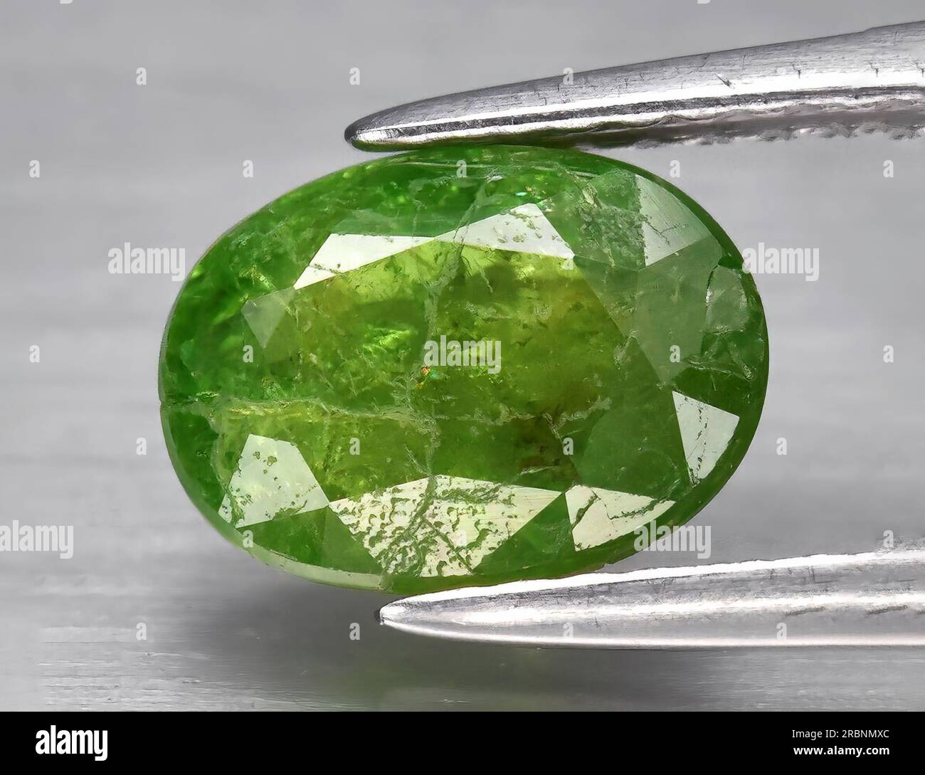 Natural gemstone green grossular garnet on gray background Stock Photo ...