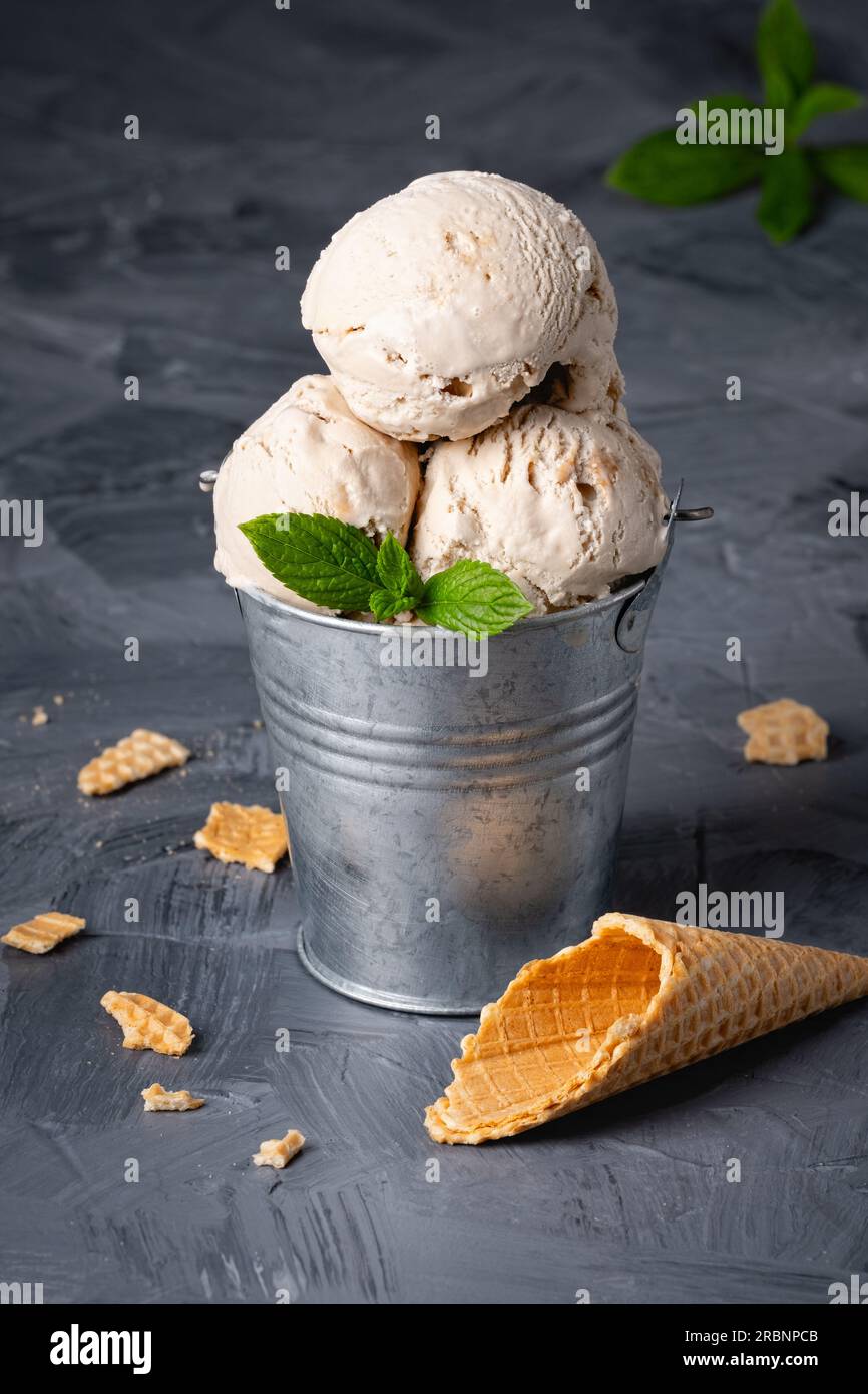 Vanilla ice cream with syrup in a metal bucket Stock Photo - Alamy
