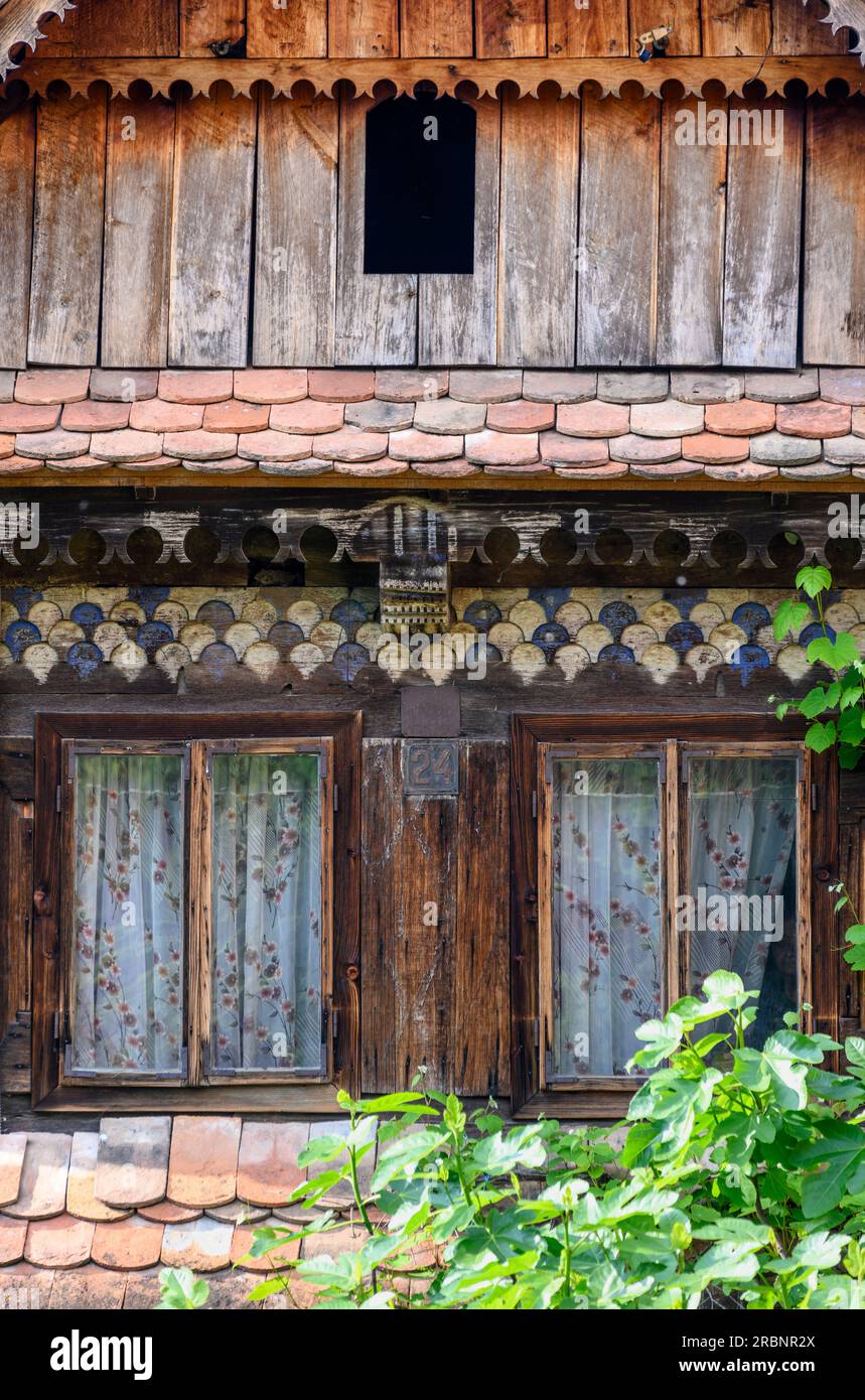 Detail of an old wooden house with traditional carved wood and painted ...