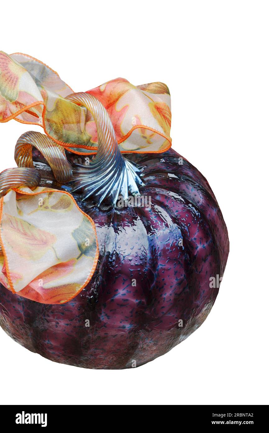 Blown glass pumpkin with colorful fall ribbon high in air has a twisted ...