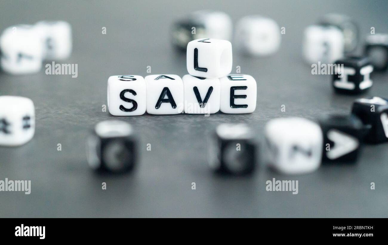 Save versus sale words in white letter block beads. Shopping and smart ...