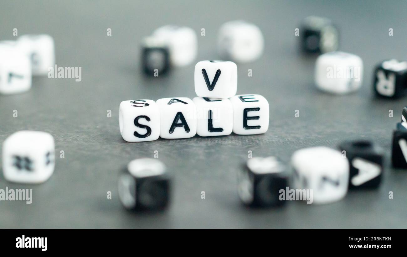 Sale versus save words in white letter block beads. Shopping and smart ...
