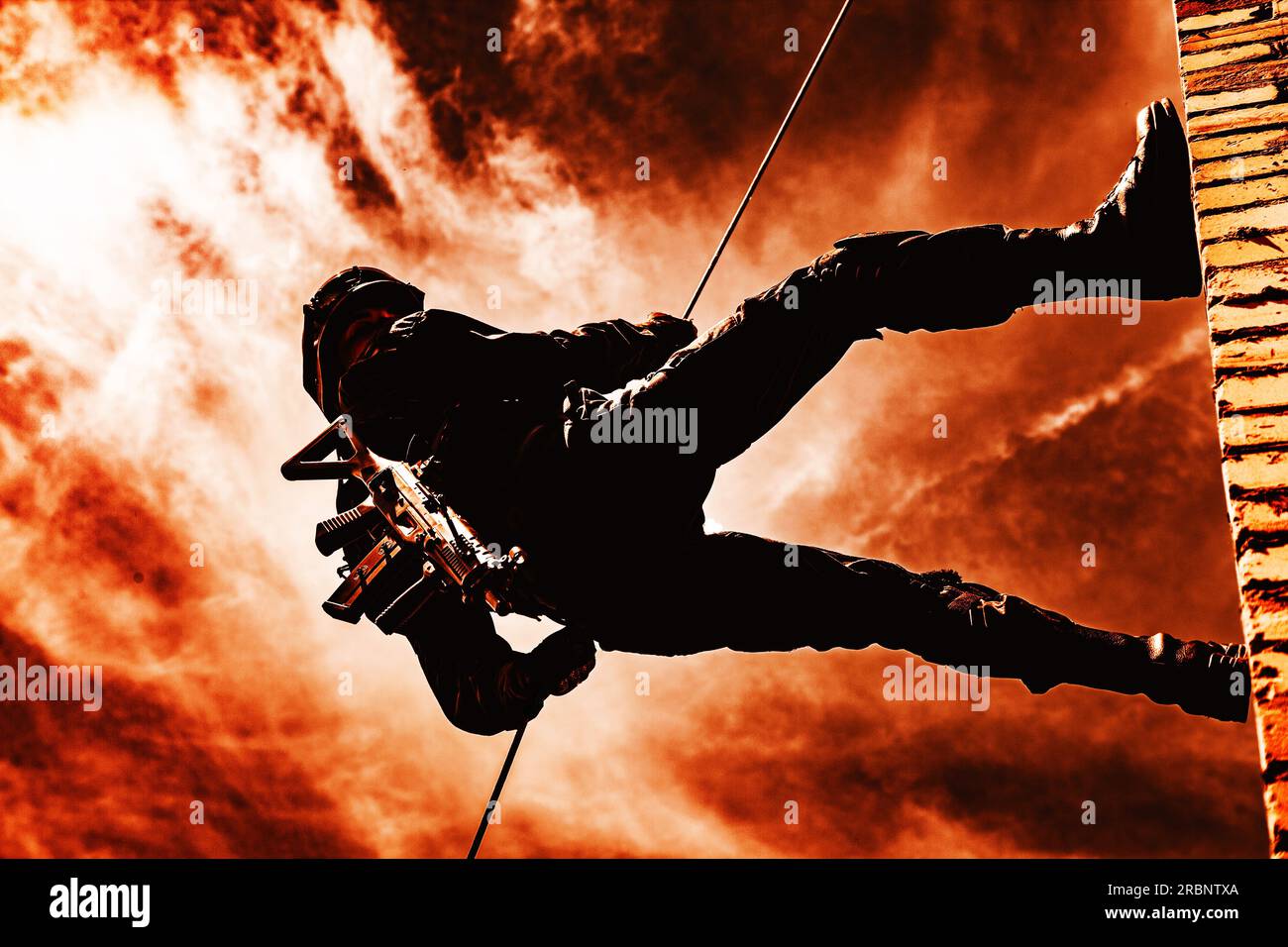 Silhouette of police officer in tactical gear descending from a height ...