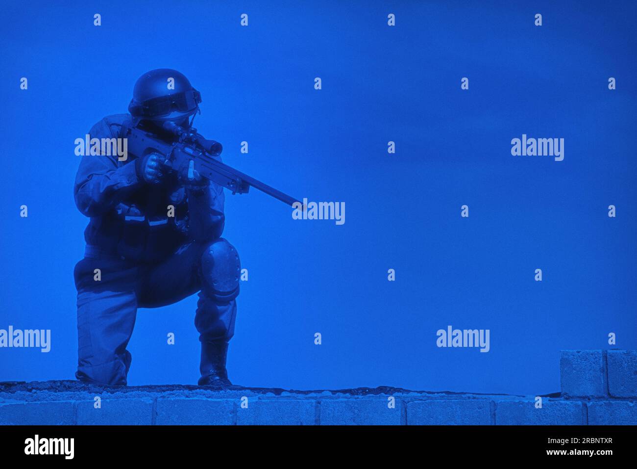 SWAT police sniper in black uniform in action on the roof top Stock ...