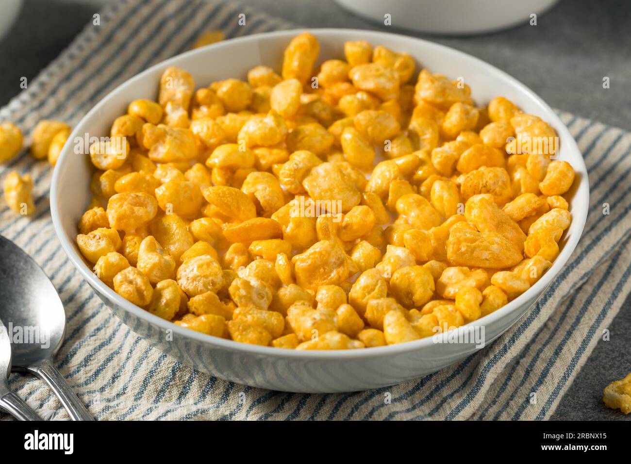 Sweet Sugar Puffed Corn Cereal for Breakfast in a Bowl Stock Photo - Alamy