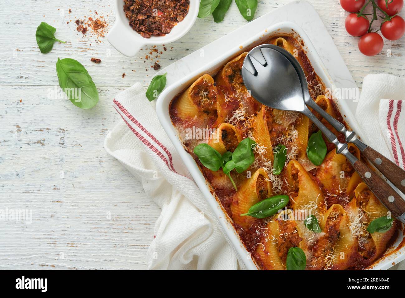 Cannelloni or conchiglioni. Baked stuffed pasta shells with bolognese ...