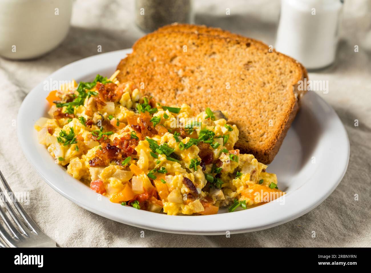 Homemade Bacon Egg Scramble with Peppers and Toast Stock Photo - Alamy