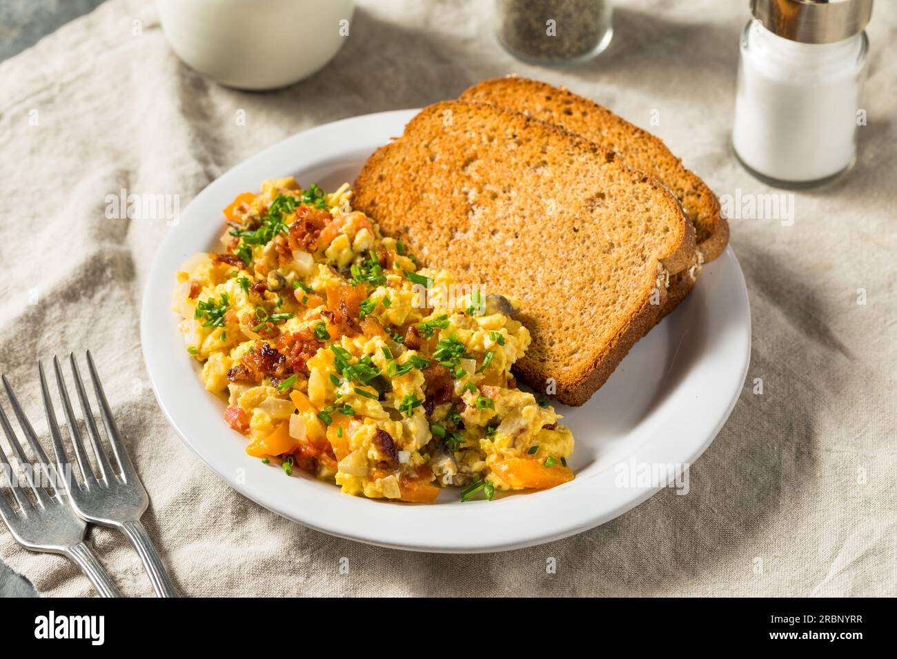 Homemade Bacon Egg Scramble with Peppers and Toast Stock Photo - Alamy