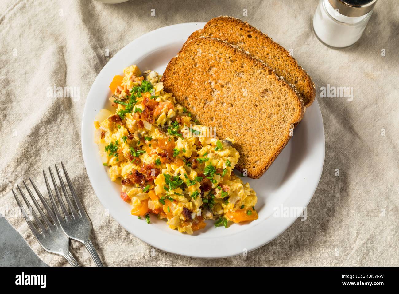 Homemade Bacon Egg Scramble with Peppers and Toast Stock Photo - Alamy