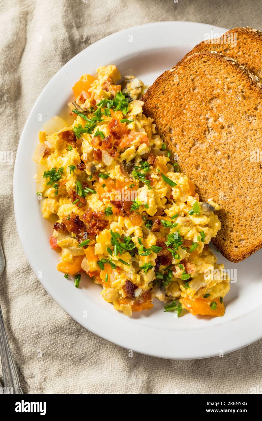 Homemade Bacon Egg Scramble with Peppers and Toast Stock Photo - Alamy