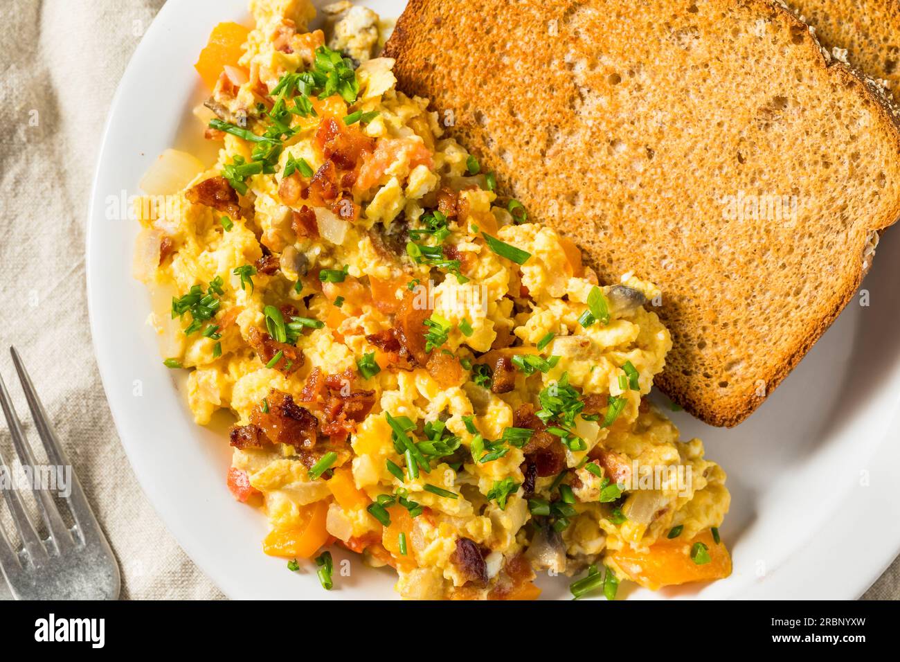 Homemade Bacon Egg Scramble with Peppers and Toast Stock Photo - Alamy