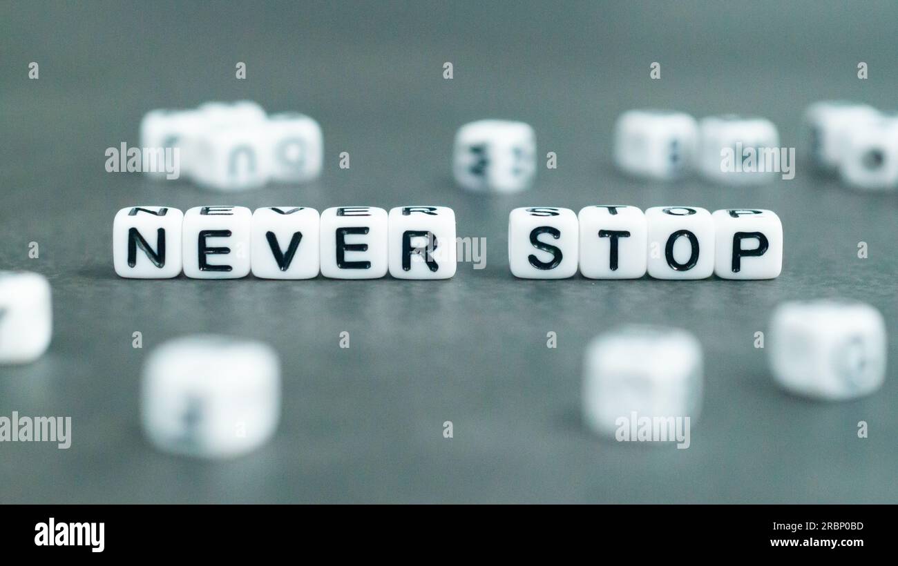 Never stop slogan in white block letter beads. Success and self ...