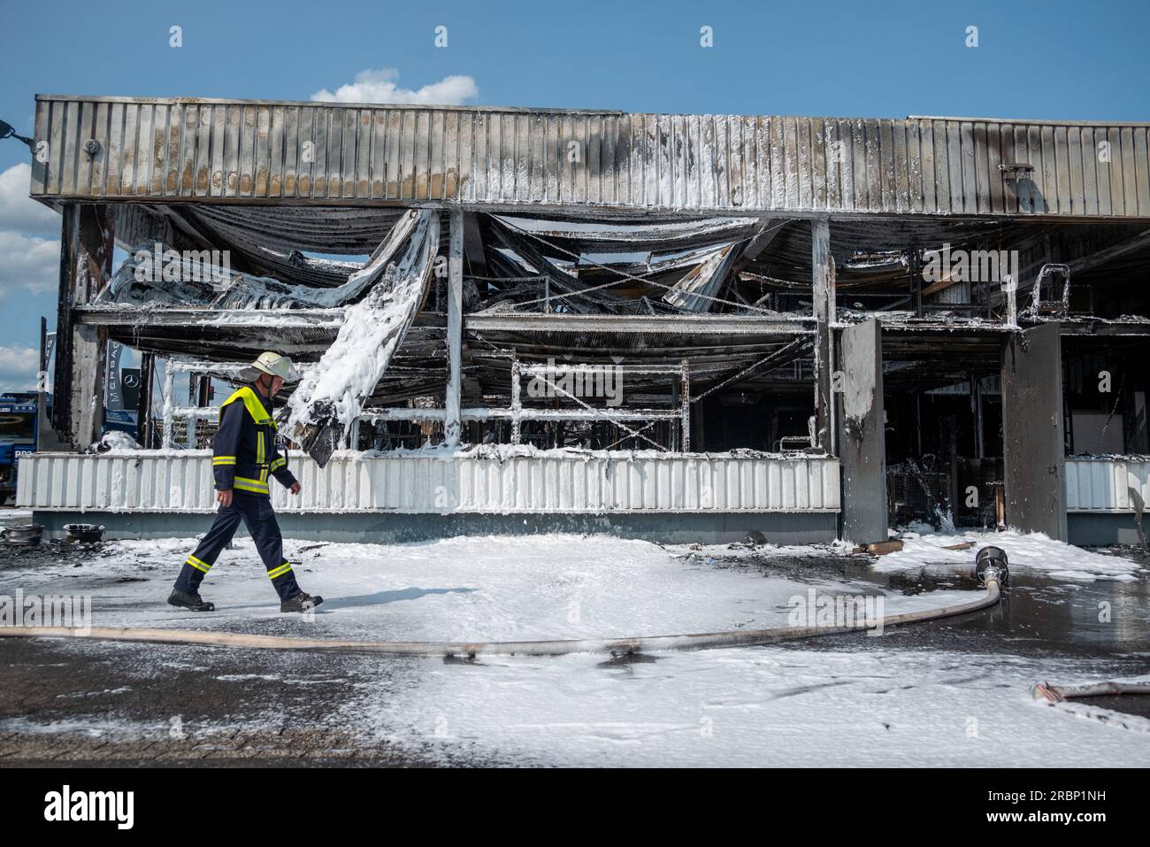 Wittlich, Germany. 10th July, 2023. A firefighter walks past a burned ...