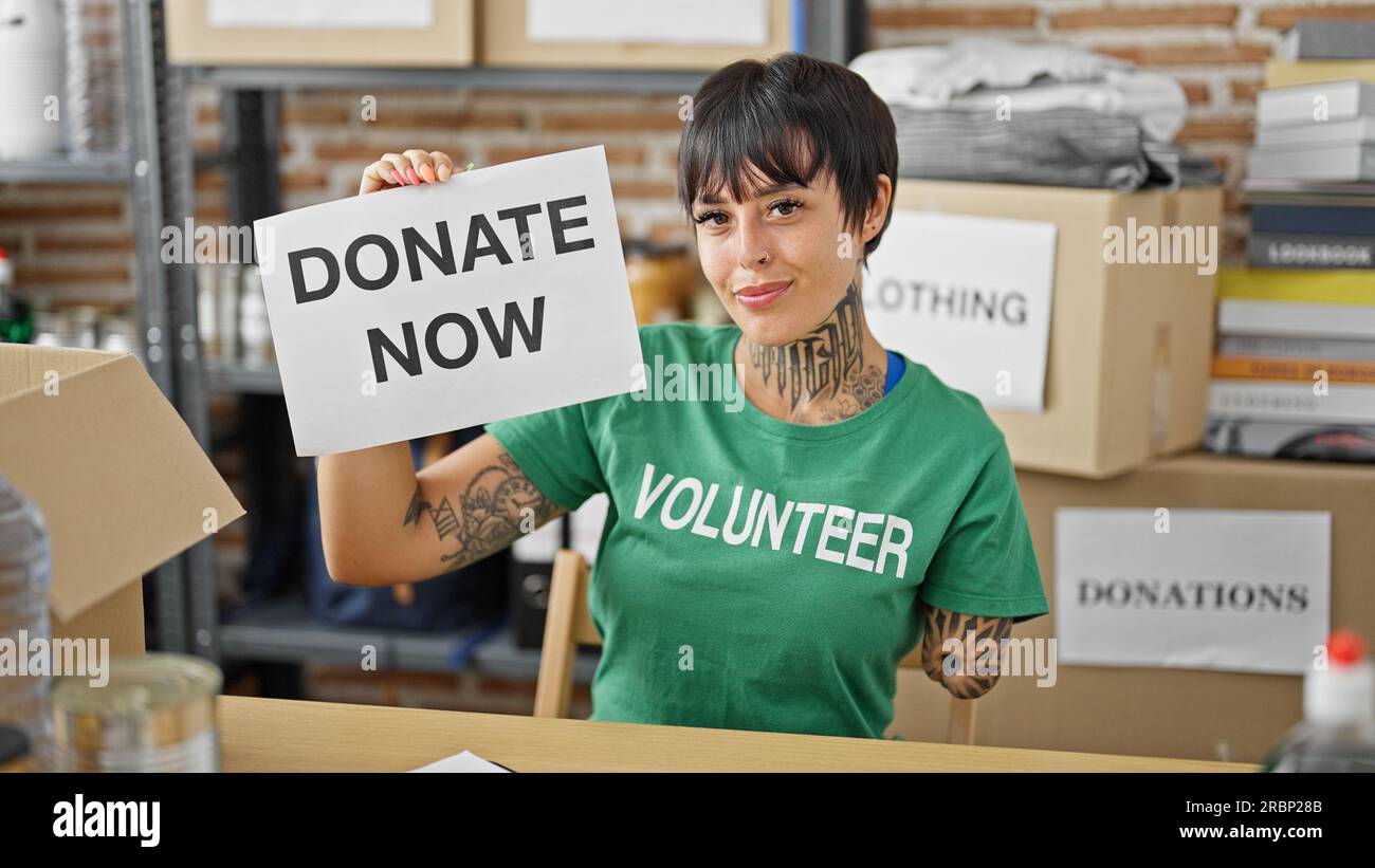 Hispanic woman with amputee arm volunteer smiling confident holding ...
