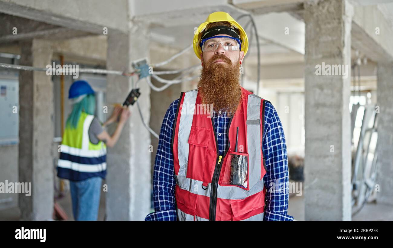 Man and woman builders standing with relaxed expression working at ...