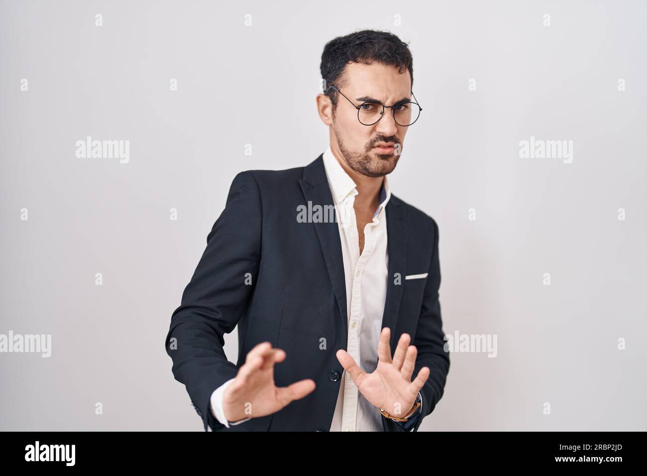 Handsome business hispanic man standing over white background disgusted ...