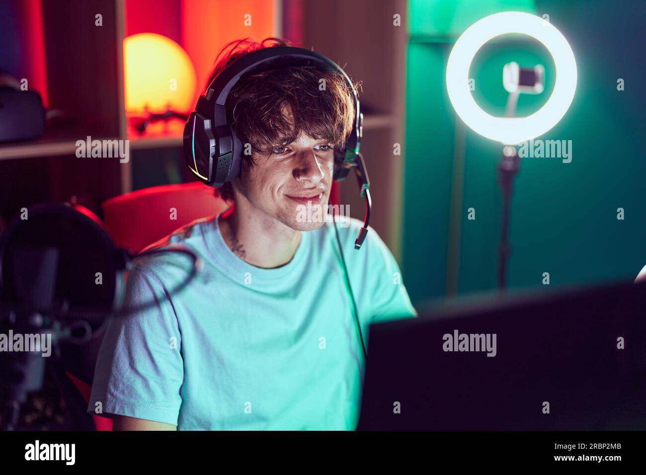 Young blond man playing video game using computer at gaming room Stock ...