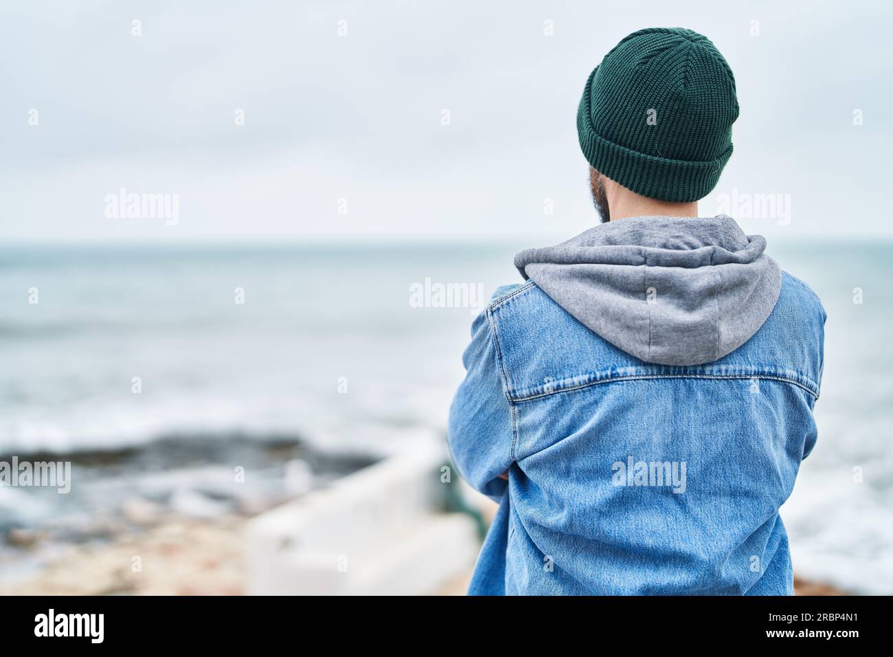 Young bald man standing on back view at seaside Stock Photo - Alamy