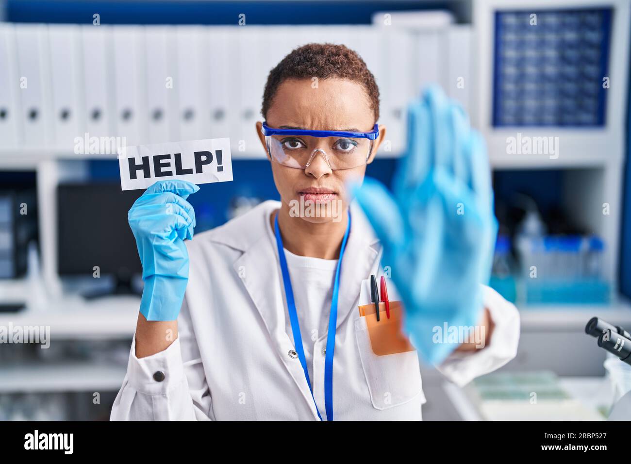 Beautiful african american woman working at scientist laboratory asking ...
